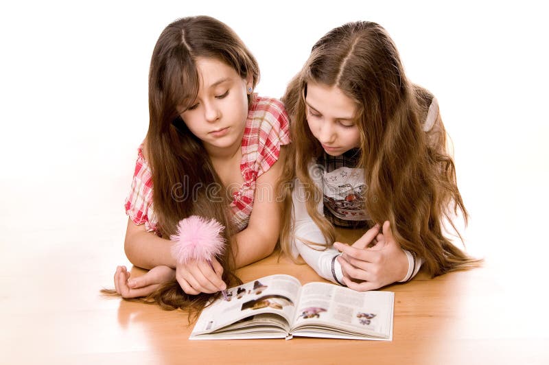 Two Girls Reading Book on the Floor on White Stock Photo - Image of ...