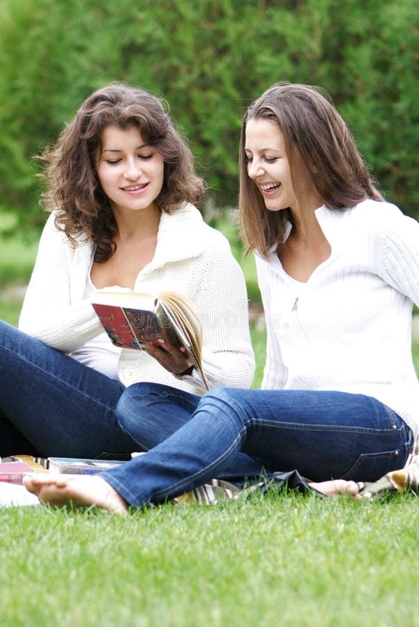 Two Girls Reading Book Outdoors Stock Image - Image of couple ...