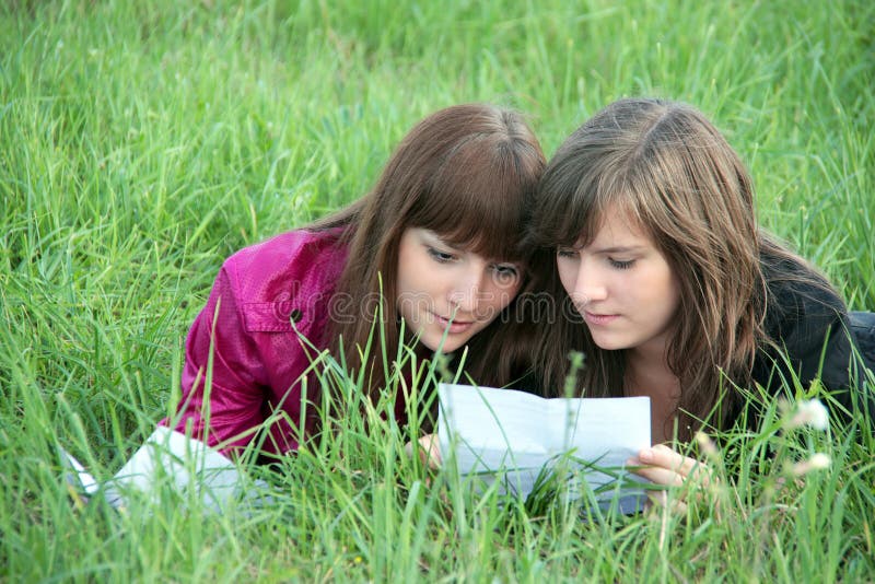 Two Girls Reading Together on Grass Stock Image - Image of reading ...