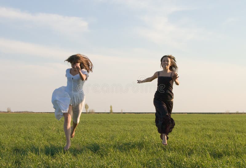 Two Girls Running on the Field 2 Stock Image - Image of girl, adult ...