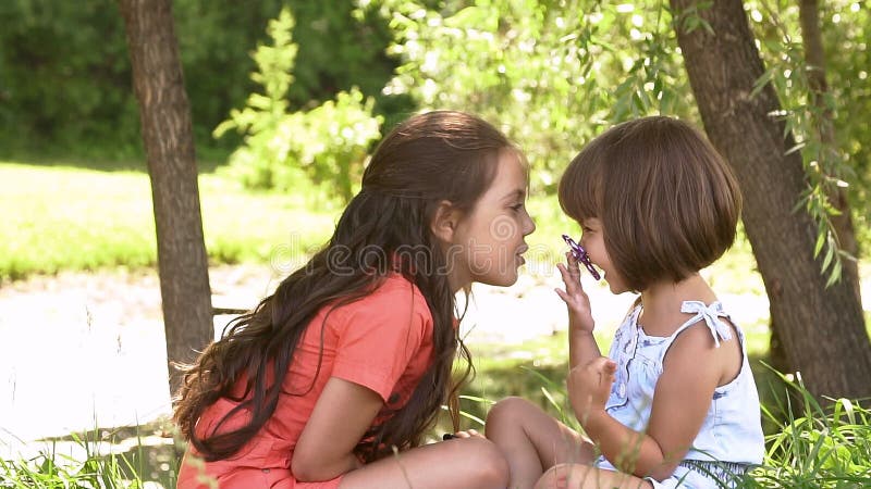 Two Girls Sisters Playing with Fidget Spinner, Slow Motion. Stock ...