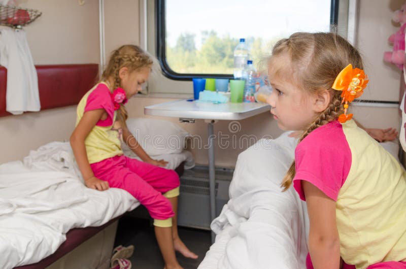 Two Girls Sisters on the Train on Lower Ground in the Second-class ...