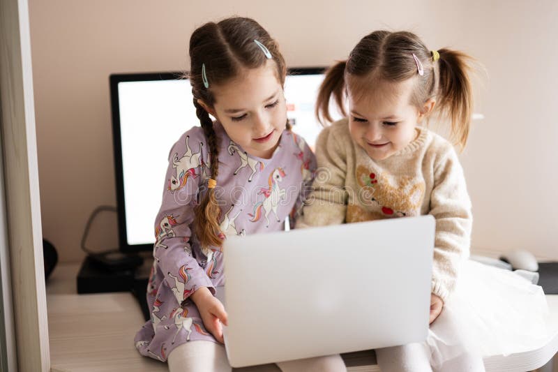Two Girls Sisters Watching on Laptop. Technology and Home Concept Stock ...