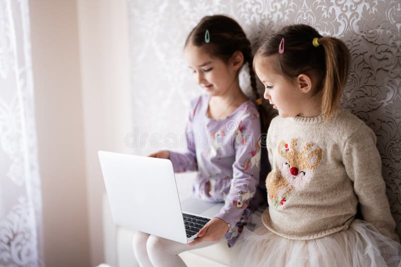 Two Girls Sisters Watching on Laptop. Technology and Home Concept Stock ...