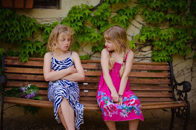 Two girls sitting on bench stock photo. Image of beauty - 280091206