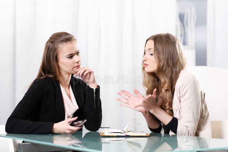 Two Girls Sitting at a Table Stock Photo - Image of discuss, happy ...