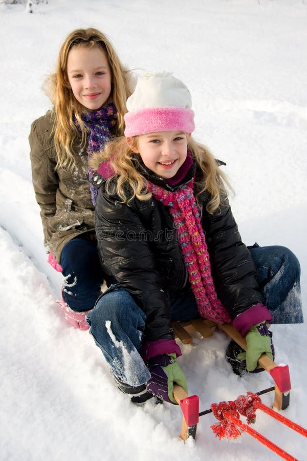 Two girls on a sled stock image. Image of playing, girls - 12256591