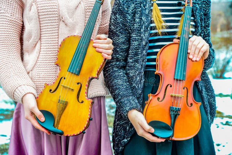 Two Girls Stand by and Hold the Violins in Their Hands Stock Photo ...