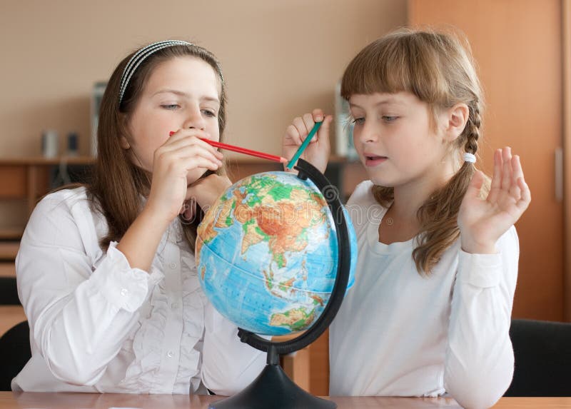 Two Girls Study Geography Using Globe Stock Photo - Image of pencil ...