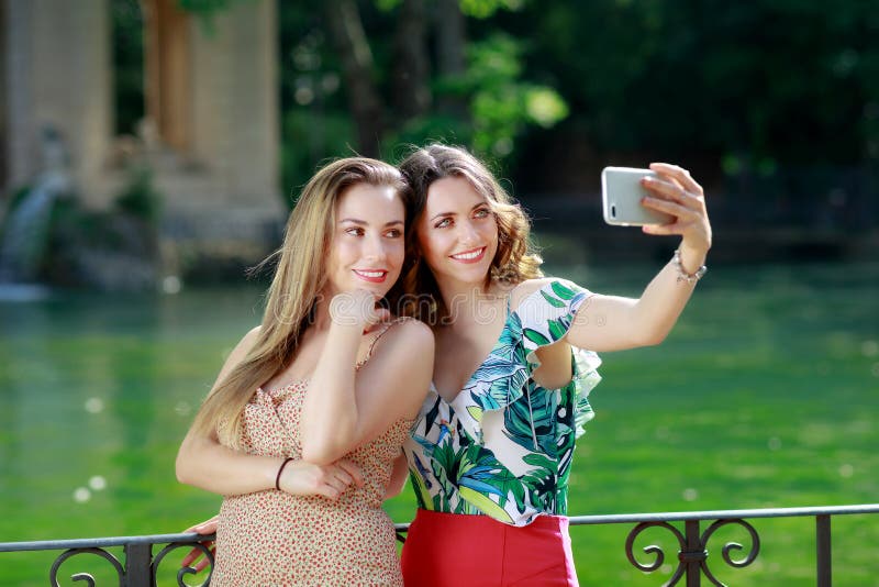 Girls Smile And Take A Selfie Together Grimaces Wink And Sign Stock