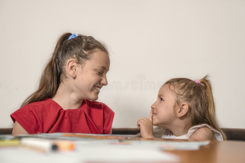 Two Girls are Talking about Something and Smiling Share Their Secrets ...