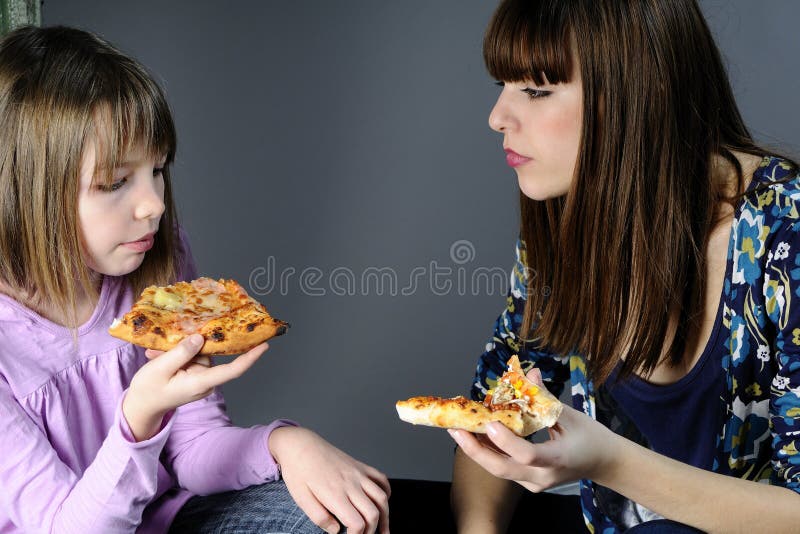 Two girls tasting food stock photo. Image of back, long - 13082908