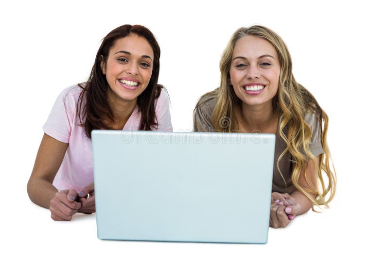 Two girls using a laptop stock photo. Image of casual - 65396254