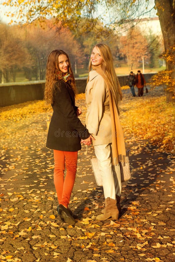 Two Girls are Walking in the Autumn Park Stock Photo - Image of sisters ...