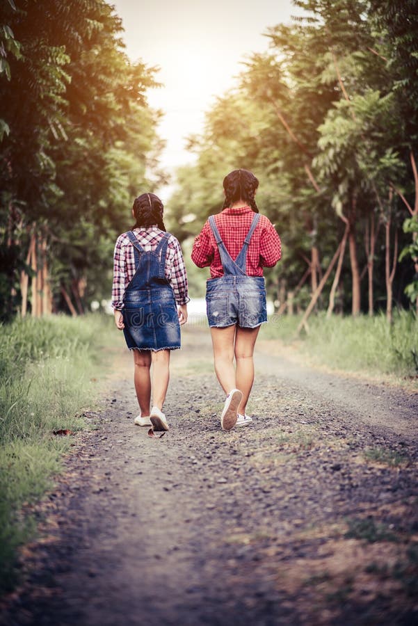 Two Girls Walking Along a Forest Stock Photo - Image of young, sisters ...