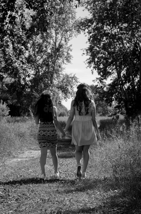 Two Girls are Walking Along a Path in the Forest. Stock Photo - Image ...