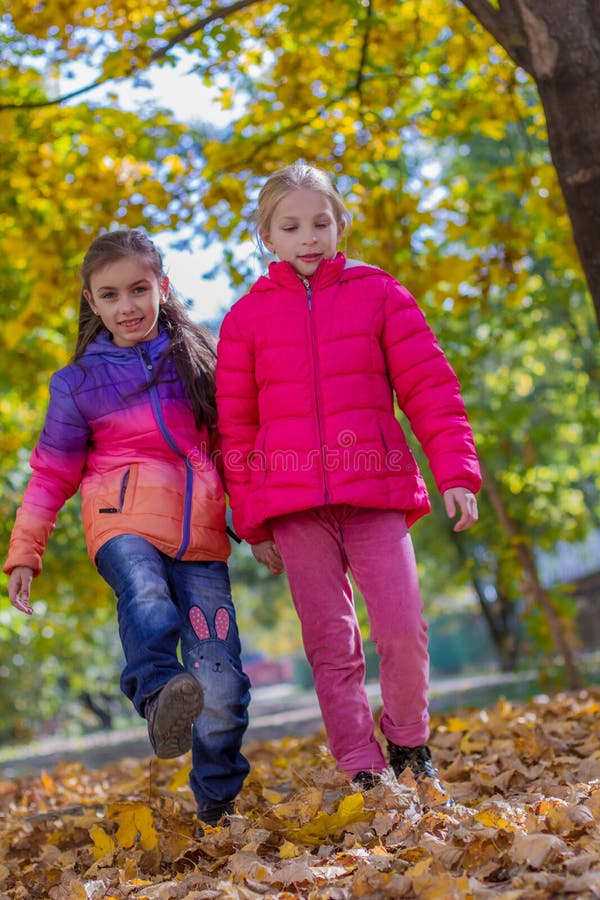 Two Girls Walking among Autumn Trees Stock Photo - Image of face ...