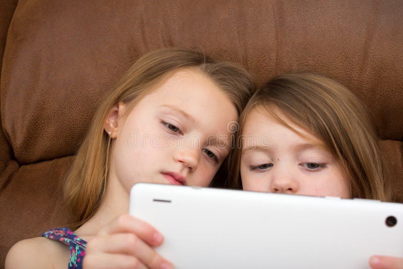 Two Girls Watching a Tablet Together Stock Photo - Image of mobile ...