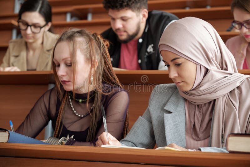Two Girls Writing Down Lecture Notes at Lesson Stock Photo - Image of ...