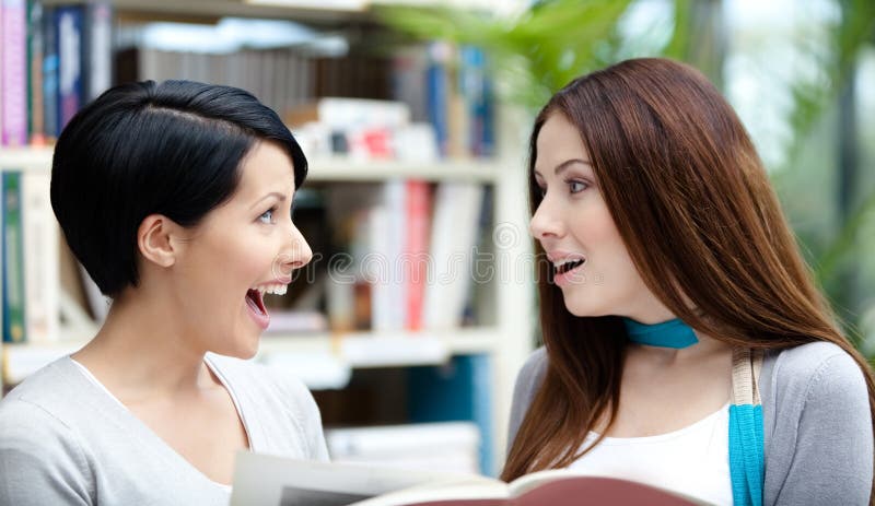 Two Glad Students Read at the Library Stock Photo - Image of cute, hand ...