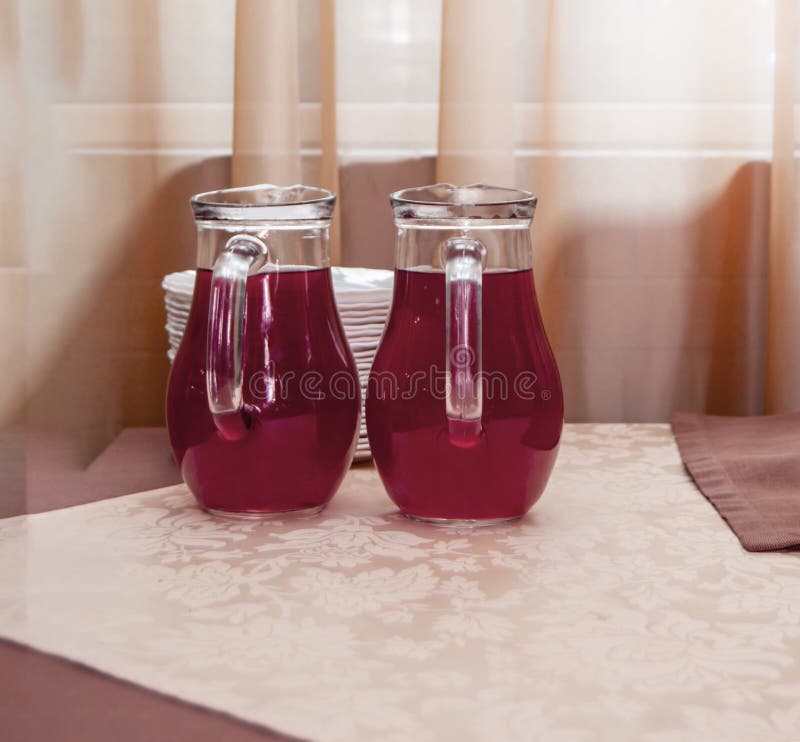 Two Glass Jugs of Cranberry Juice on the Table Stock Image - Image of ...