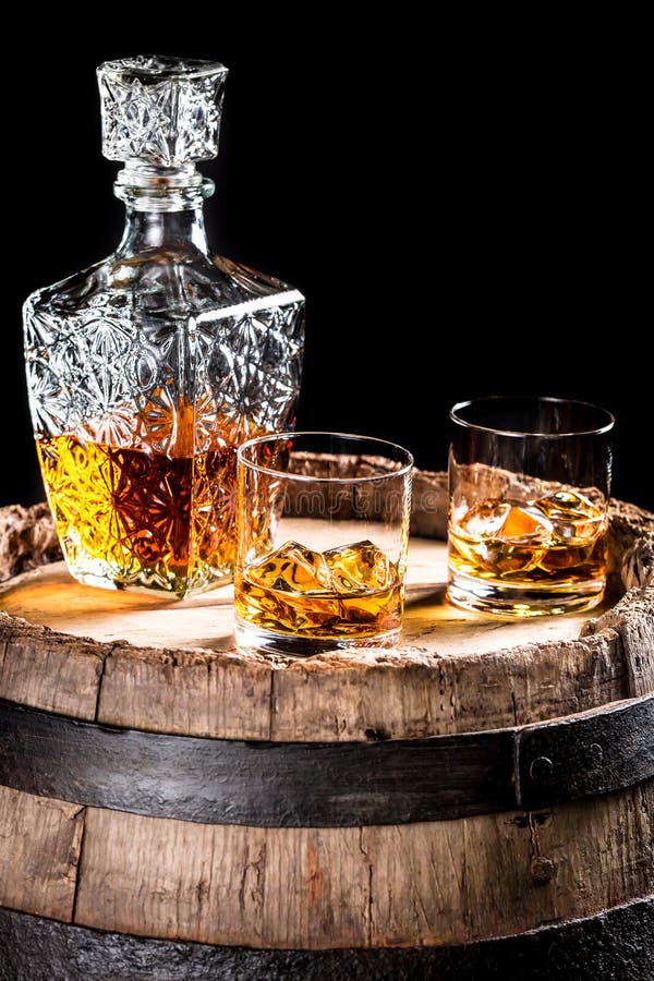 Two Glassed of Aged Brandy or Whiskey on the Rocks Stock Image - Image ...