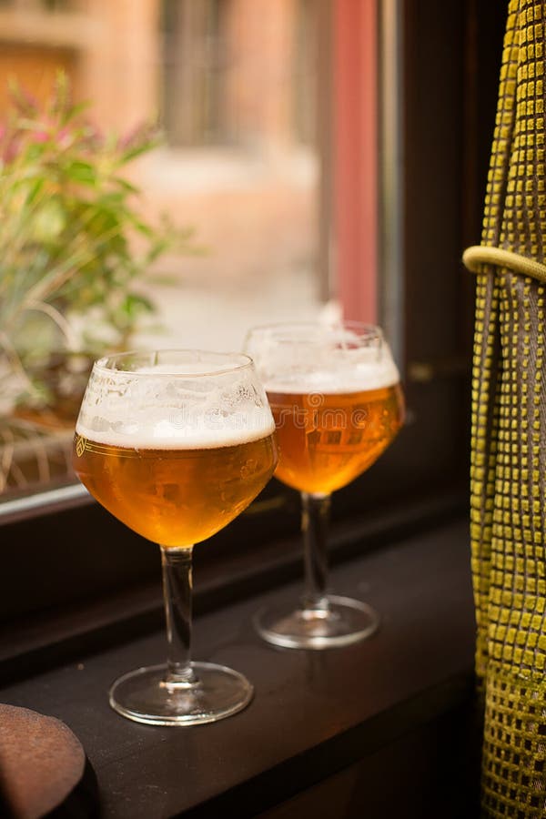 A Glass with Belgian Beer on the Window Stock Image - Image of lager ...
