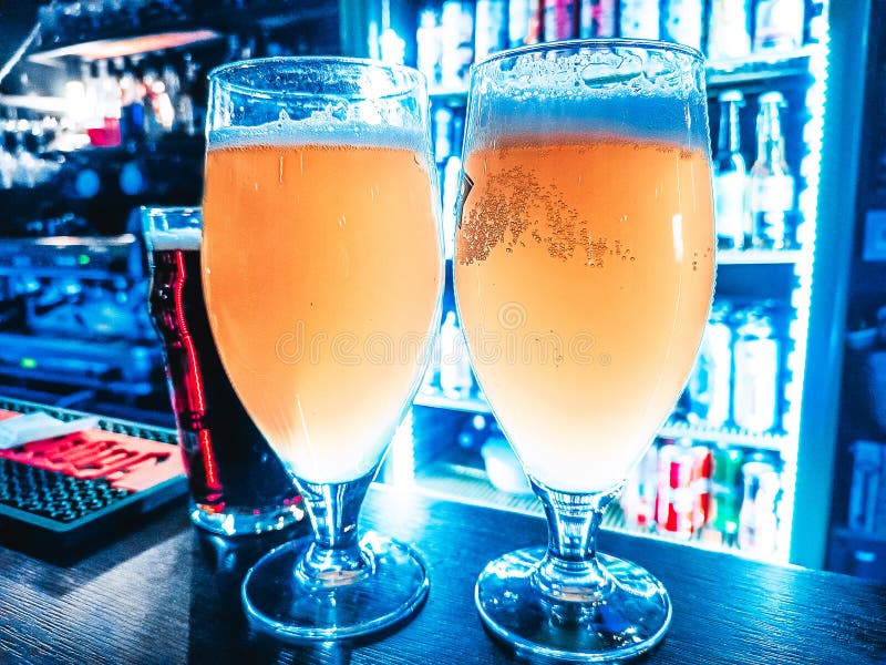 Two Glasses of Cold Foamy Beer on Bar Counter Stock Image - Image of ...