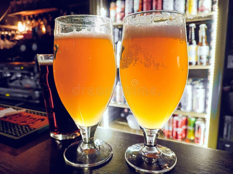 Two Glasses of Cold Foamy Beer on Bar Counter Stock Photo - Image of ...