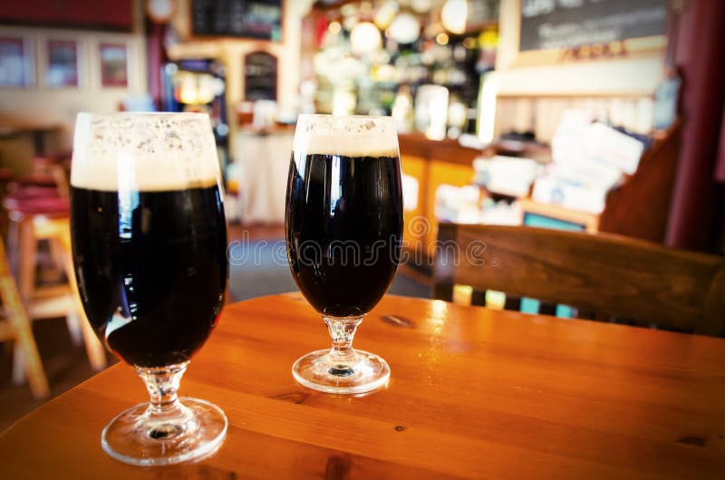 Two Glasses of Dark Beer in a Bar Stock Photo - Image of beverage, hops ...
