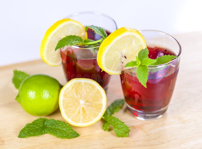 Two Glasses of Red Fruit Juice with Lemon and Lime Stock Photo - Image ...