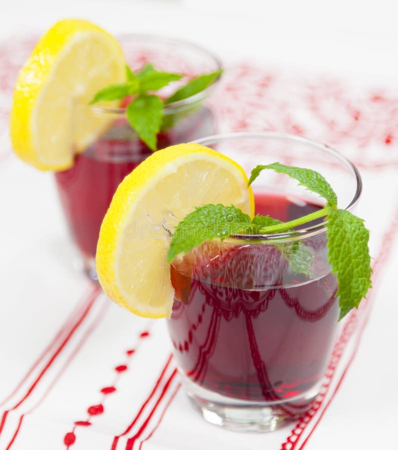 Two Glasses of Red Fruit Juice with Lemon Stock Photo - Image of ...