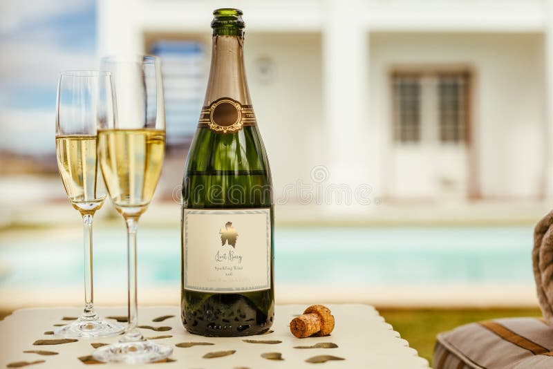 Two Glasses of Sparkling Wine with Bottle at the Poolside Editorial ...
