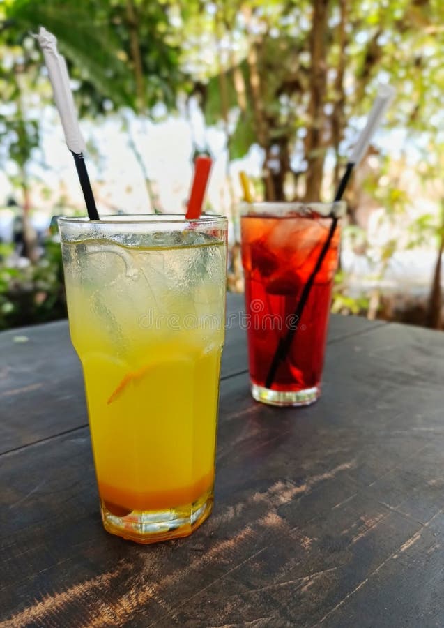 Two Glasses on the Table, Iced Orange Juice and Iced Strawberry Tea ...