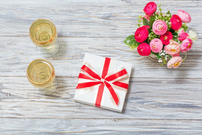 Two Glasses of White Wine, Flowers and a Gift Stock Photo - Image of ...