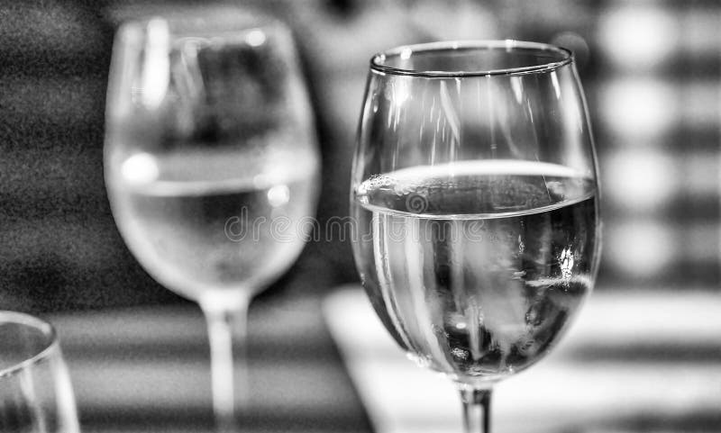 Two Glasses of White Wine Standing Side by Side in a Close Up View Over ...