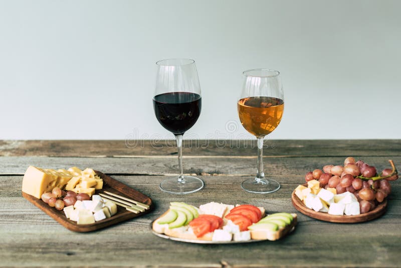 Two Glasses of Wine and Food on a Stock Image - Image of meal, white ...