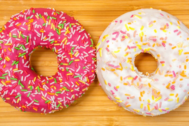 Two Glazed Donuts on a Bamboo Board Background Stock Photo - Image of ...