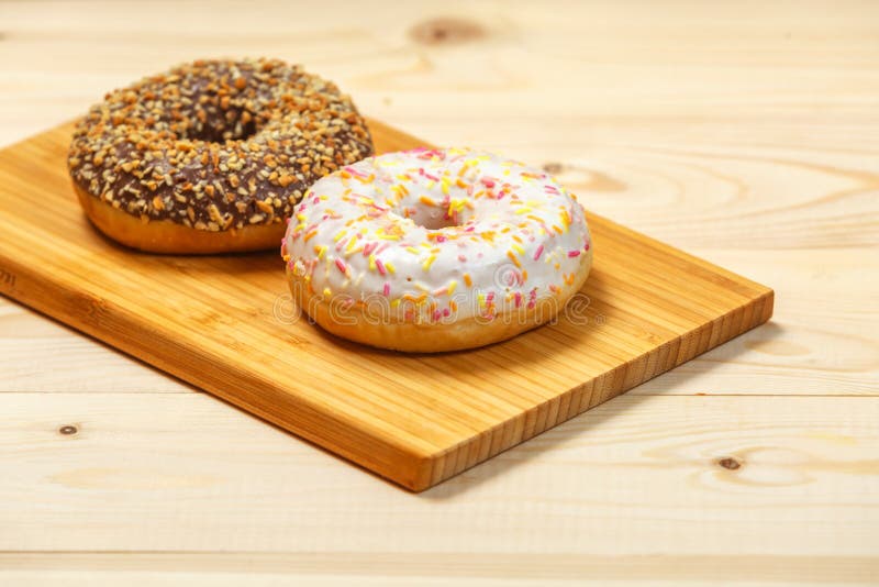 Two Glazed Donuts on a Bamboo Board Background Stock Photo - Image of ...