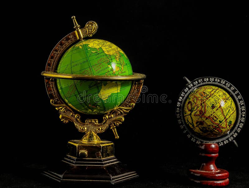 Two Globes, One Green and One Red, Sit on a Black Background Stock ...