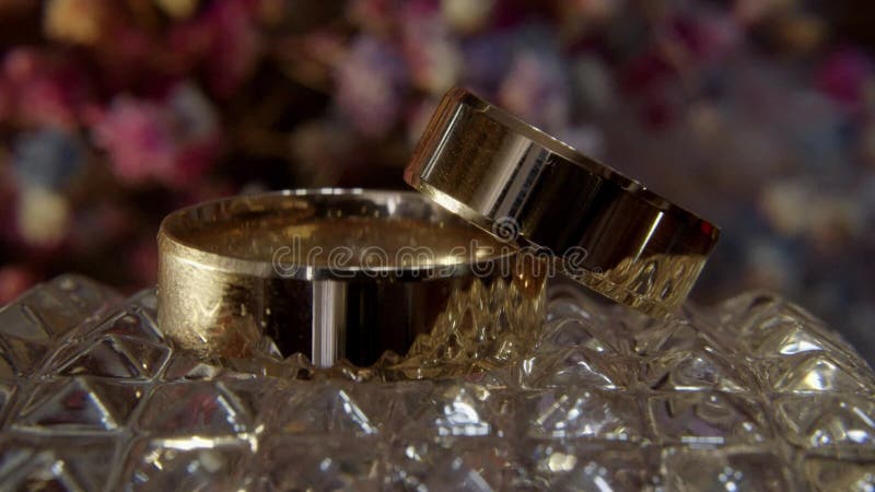 Two Gold Wedding Rings Lying on the Crystal Surface. Transfusion of ...