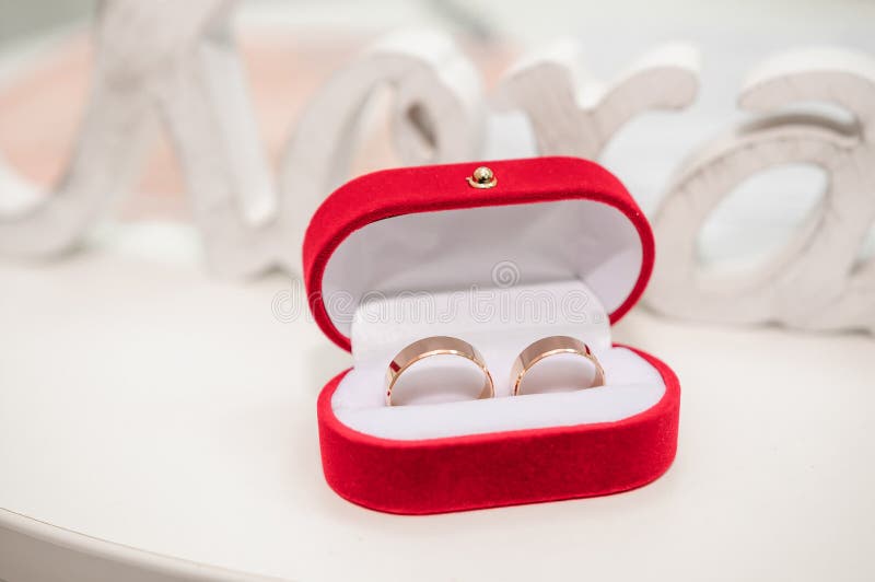 Two Gold Wedding Rings in a Red Box on the Table Stock Image - Image of ...