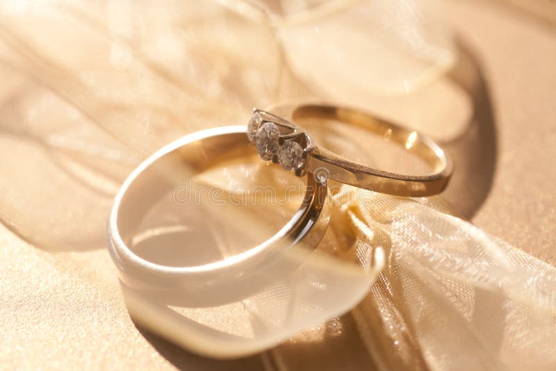 Two Gold Wedding Rings with Tender Ribbon Around Stock Image - Image of ...