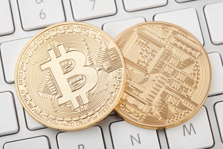 Two Golden Bitcoin Front and Back on Computer Keyboard Editorial ...