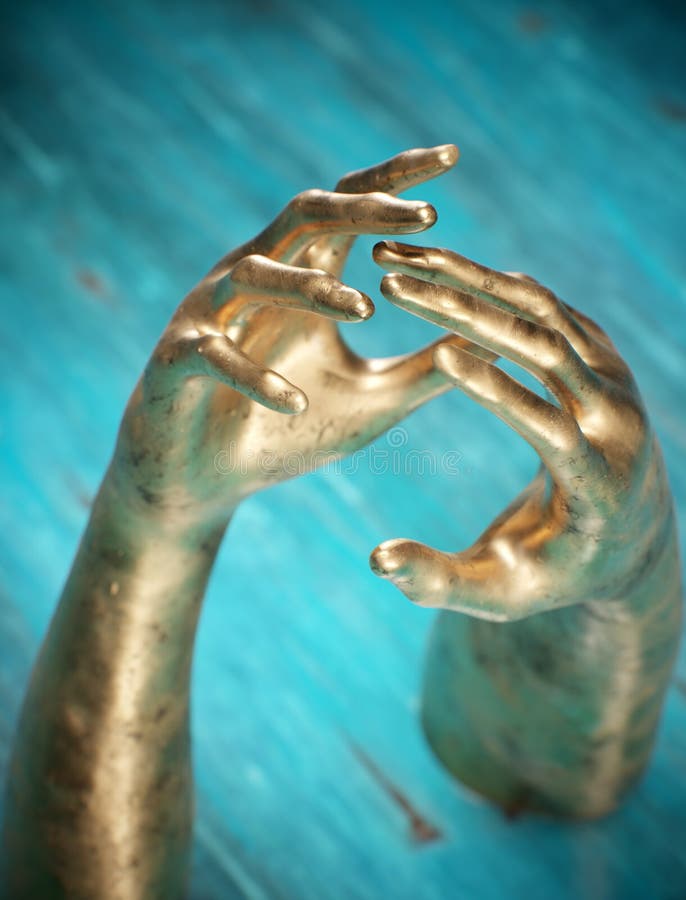 Two Golden Hands on a Blue Green Background Stock Photo - Image of blue ...