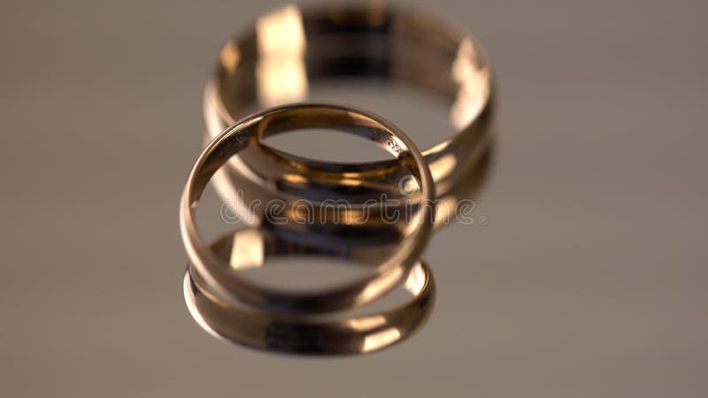 Two Wedding Rings Lie on the Table and Illuminated by a Bright Beam of ...