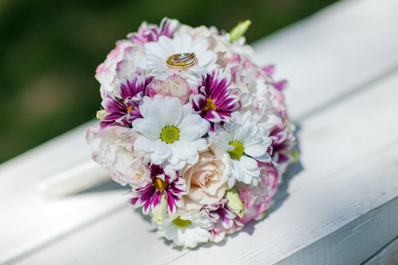 Two Golden Wedding Rings on the Spring Flowers Bouquet. Stock Image ...