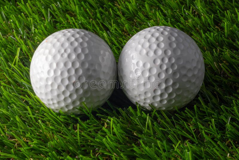 Two golf ball on grass stock image. Image of hole, grass - 142360541
