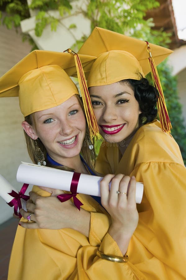 Two Graduates Holding Diploma and Flowers Stock Image - Image of ...