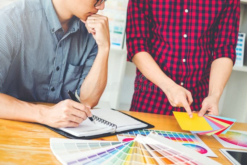 Two Graphic Designer Brainstorming Meeting and Drawing on Graphics ...